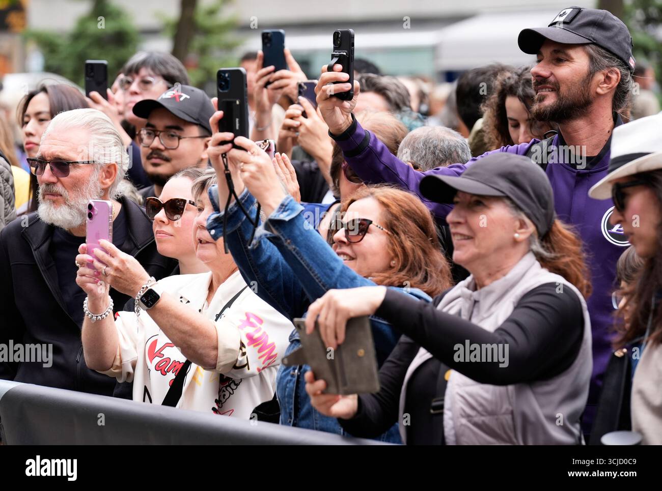People in a crowd record celebrities outside the premiere of "You Had ...