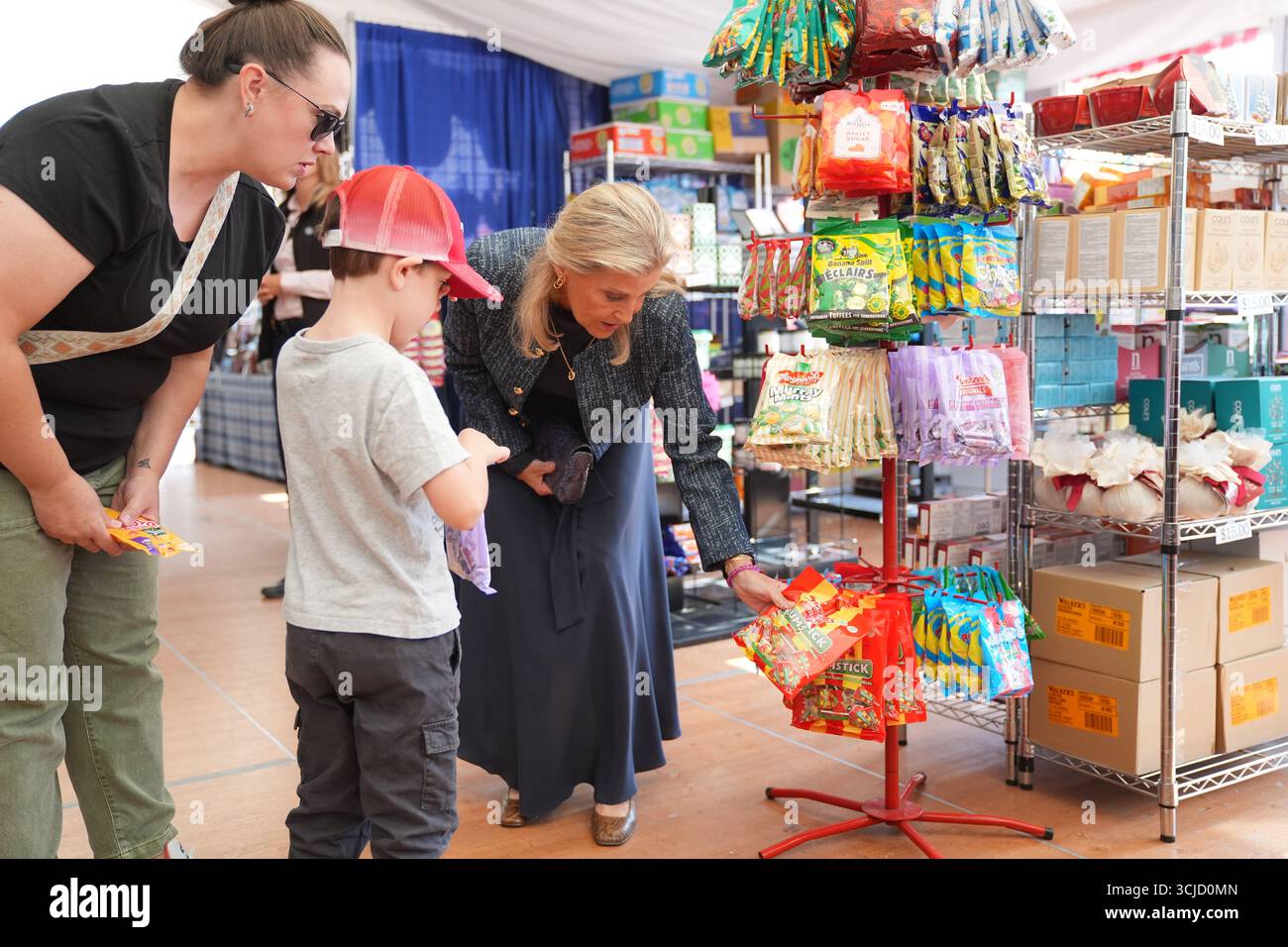 The Duchess of Edinburgh discusses her favourite sweets with a young ...