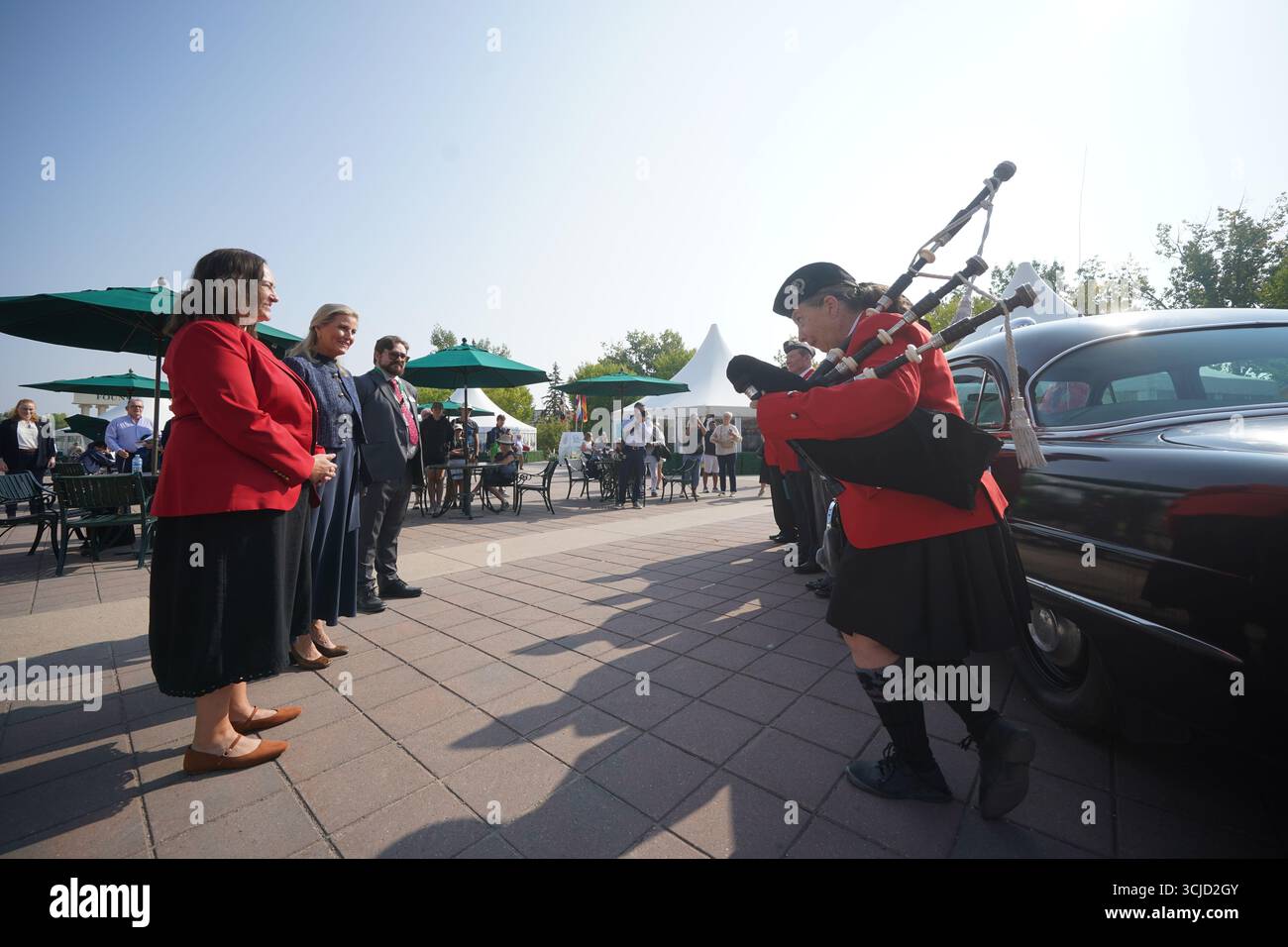 The Duchess of Edinburgh (centre left) is greeted by a piper during a ...
