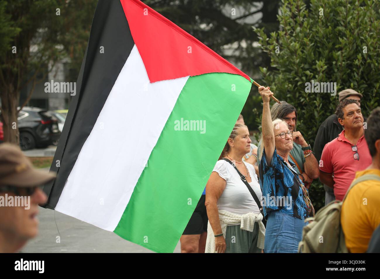 Oviedo, Spain, September 6, 2025: A woman carries a Palestinian flag ...