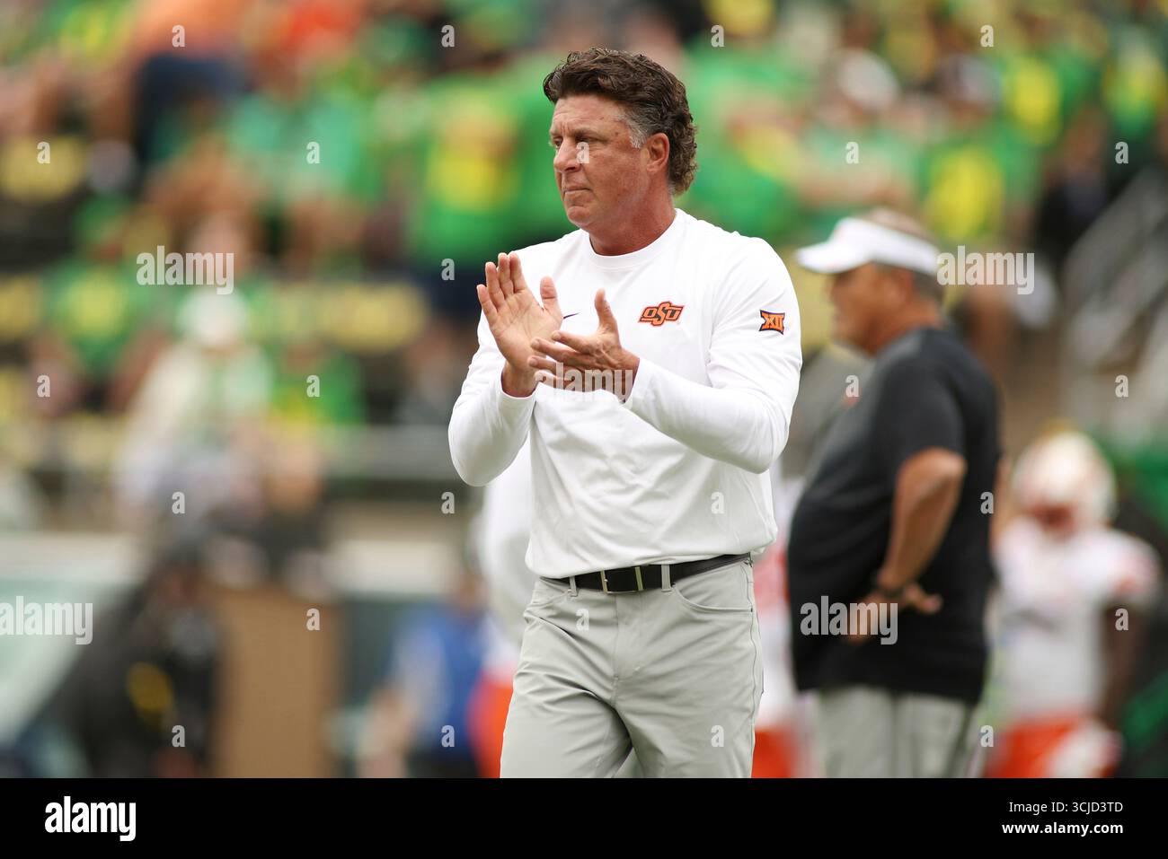Oklahoma State head coach Mike Gundy watches warmups before an NCAA ...