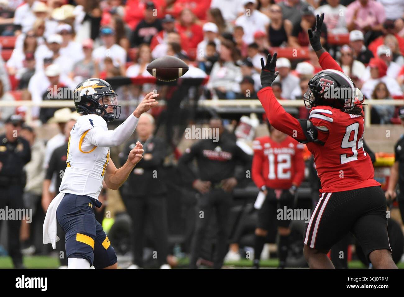 Kent State quarterback Dru DeShields, left, throws a pass as Texas Tech ...