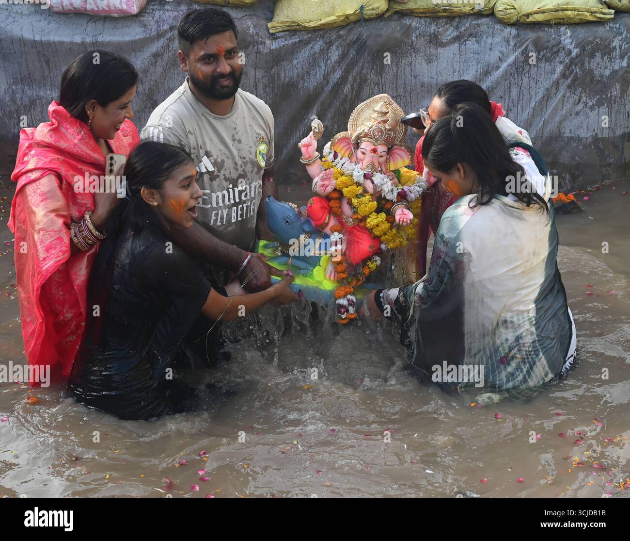 NEW DELHI, INDIA - SEPTEMBER 6: Devotees immersed the idol of Shree ...