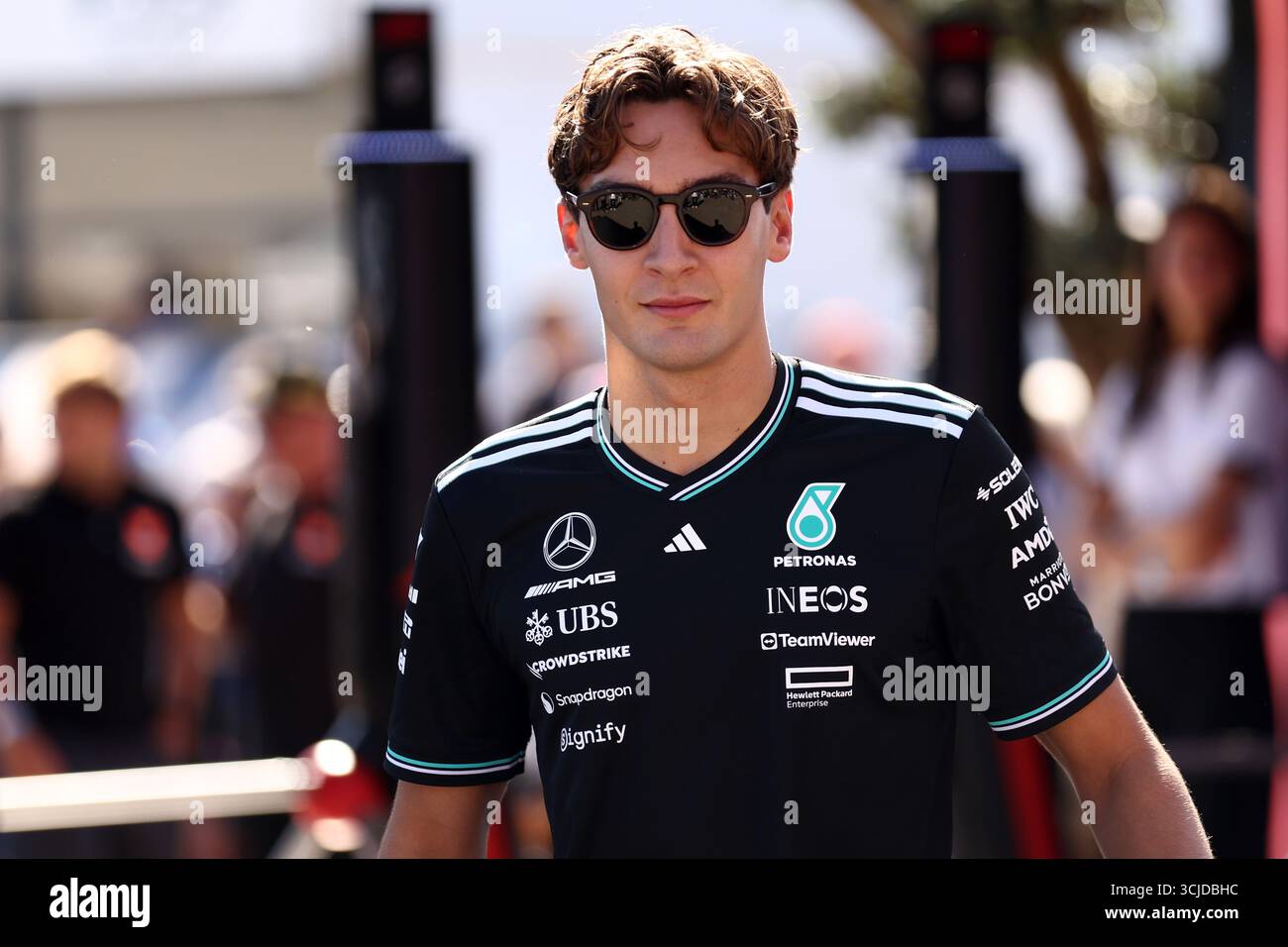 George Russell of Mercedes-AMG F1 Team looks on in the Paddock during ...