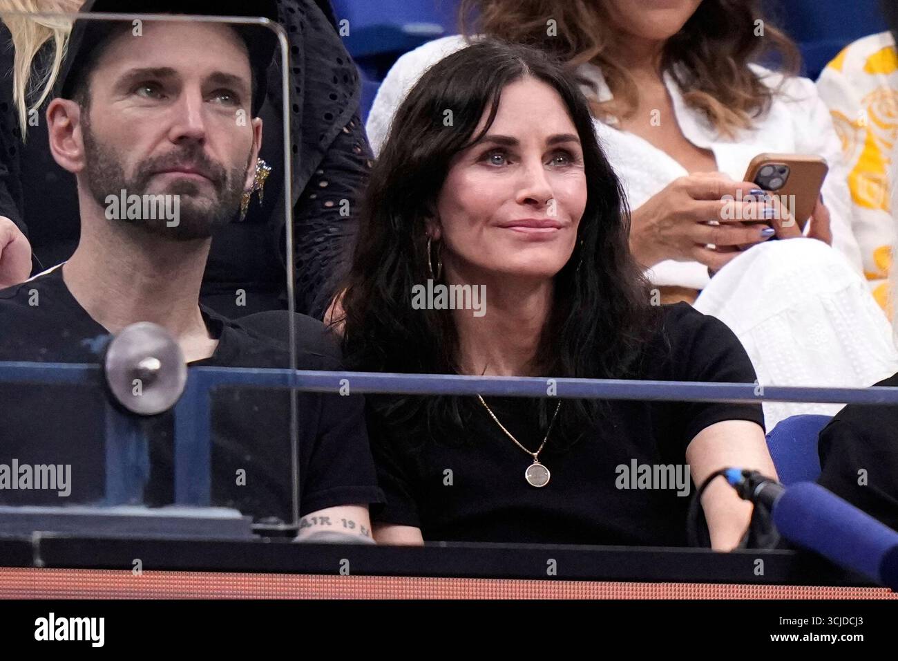Courteney Cox watches during the women's finals of the U.S. Open tennis ...
