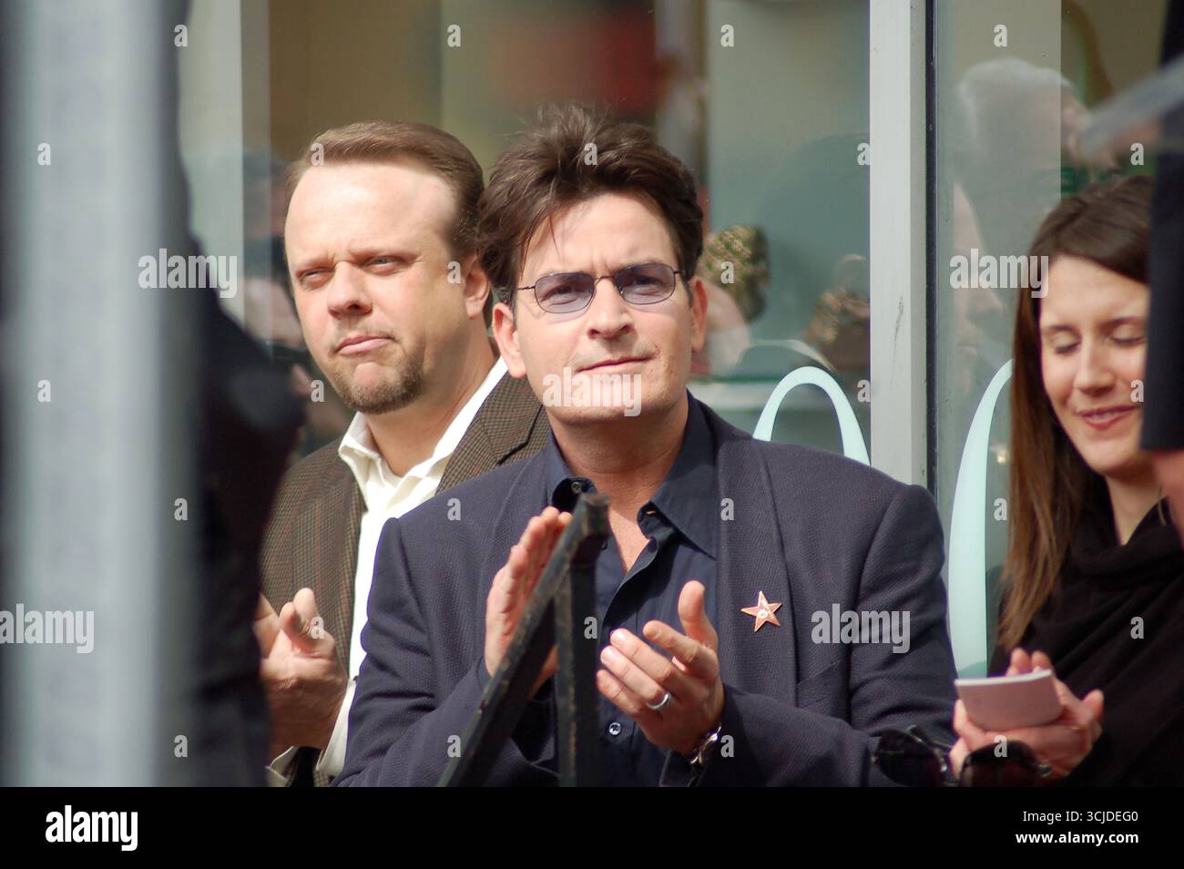Actor Charlie Sheen applauds during Chuck Lorre’s Hollywood Walk of ...