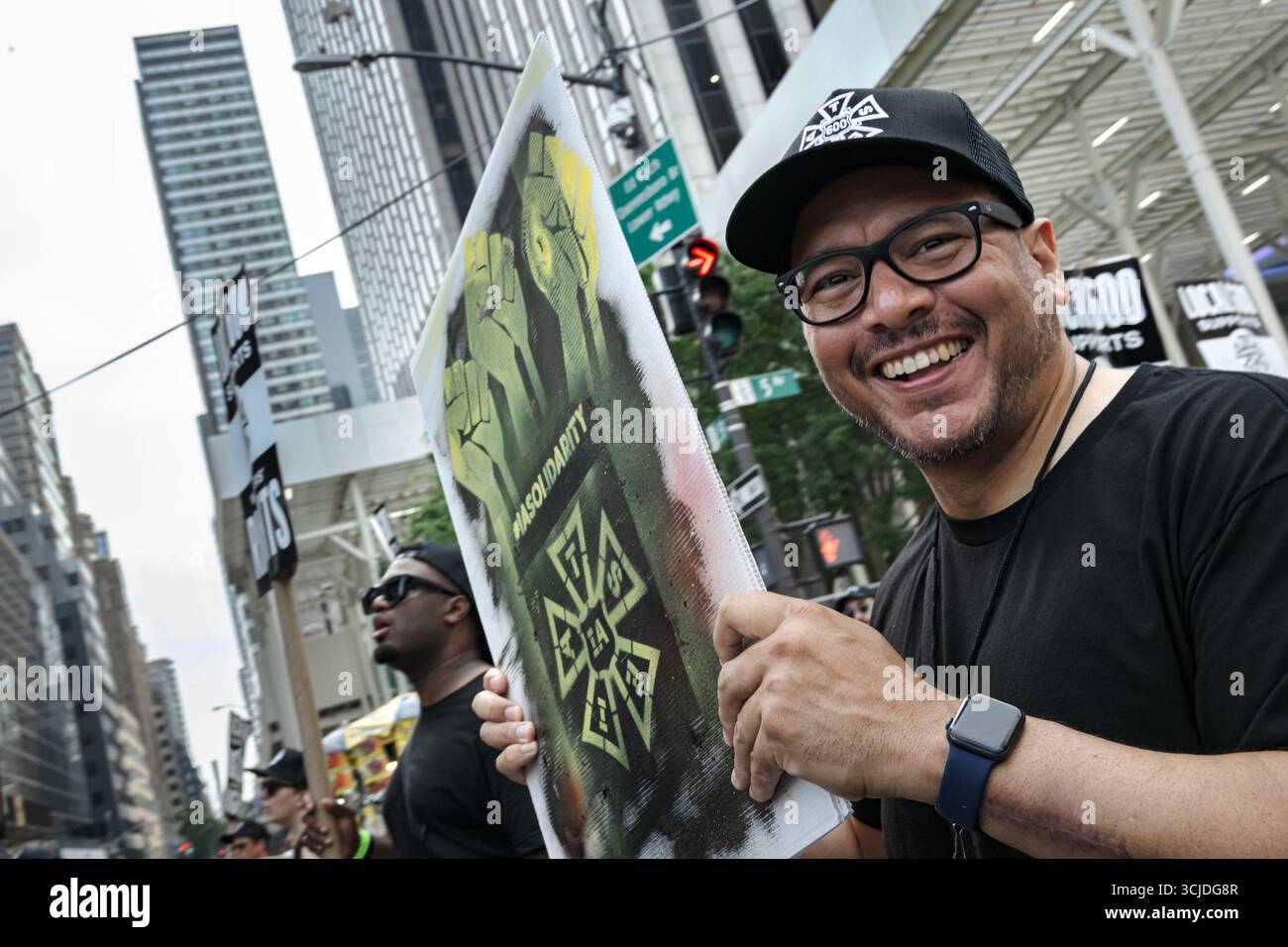 IATSE Local 600 member, Eric Veras marches with his fellow union ...