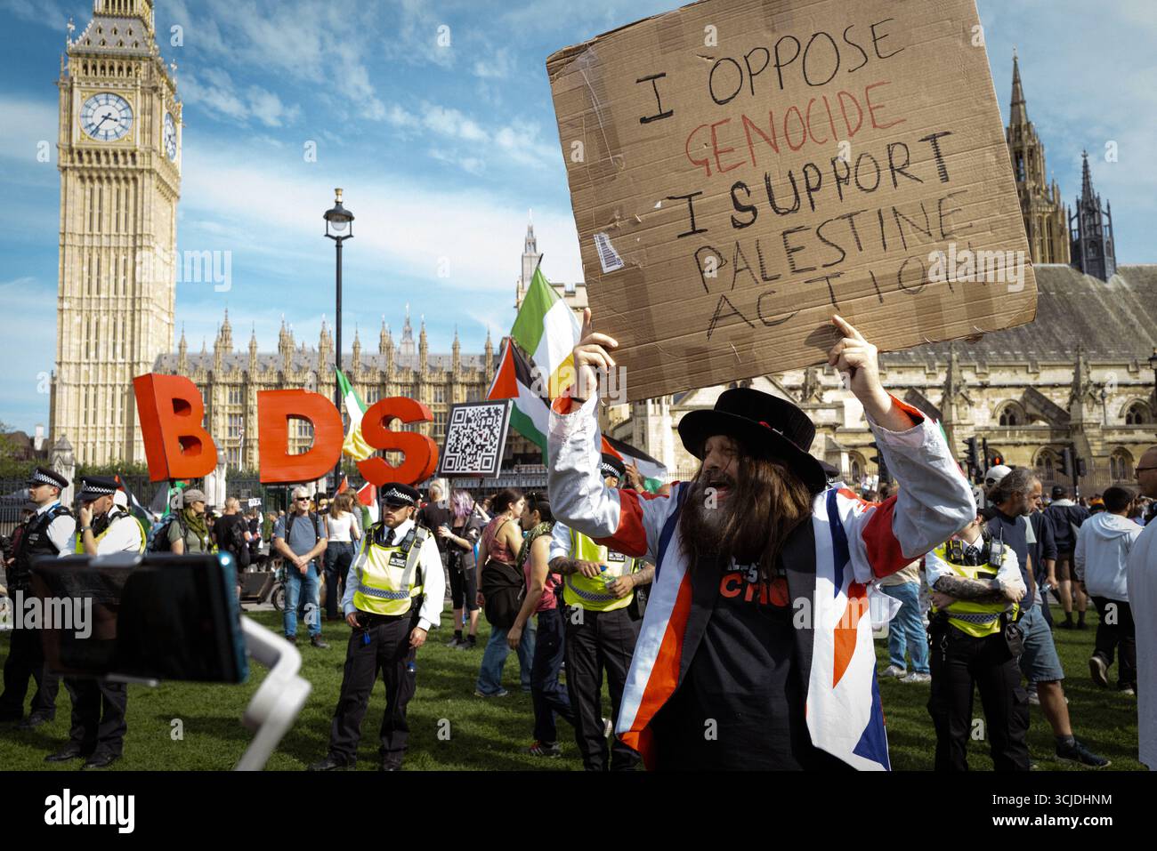 A protester holds a placard up outside the Houses Of Parliament. Over a ...