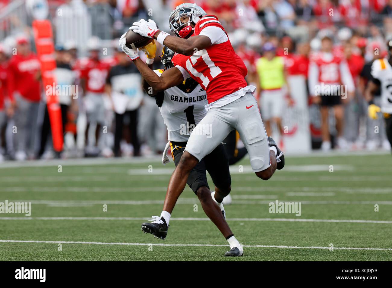 Ohio State receiver Carnell Tate, front, catches a pass against ...