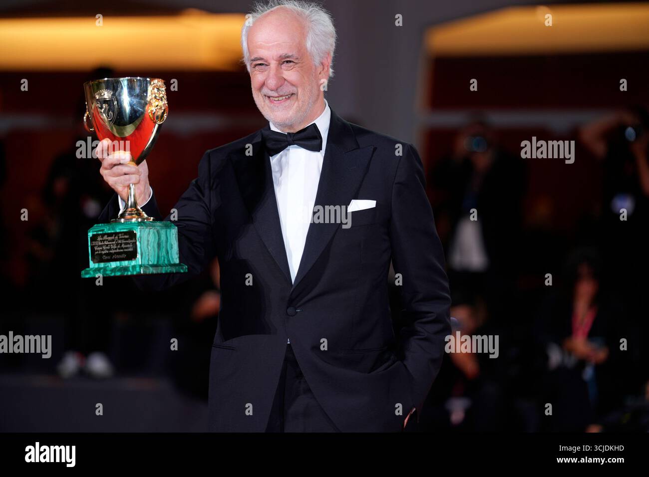 Venice, Italy. 06th Sep, 2025. Toni Servillo poses with the Coppa Volpi ...