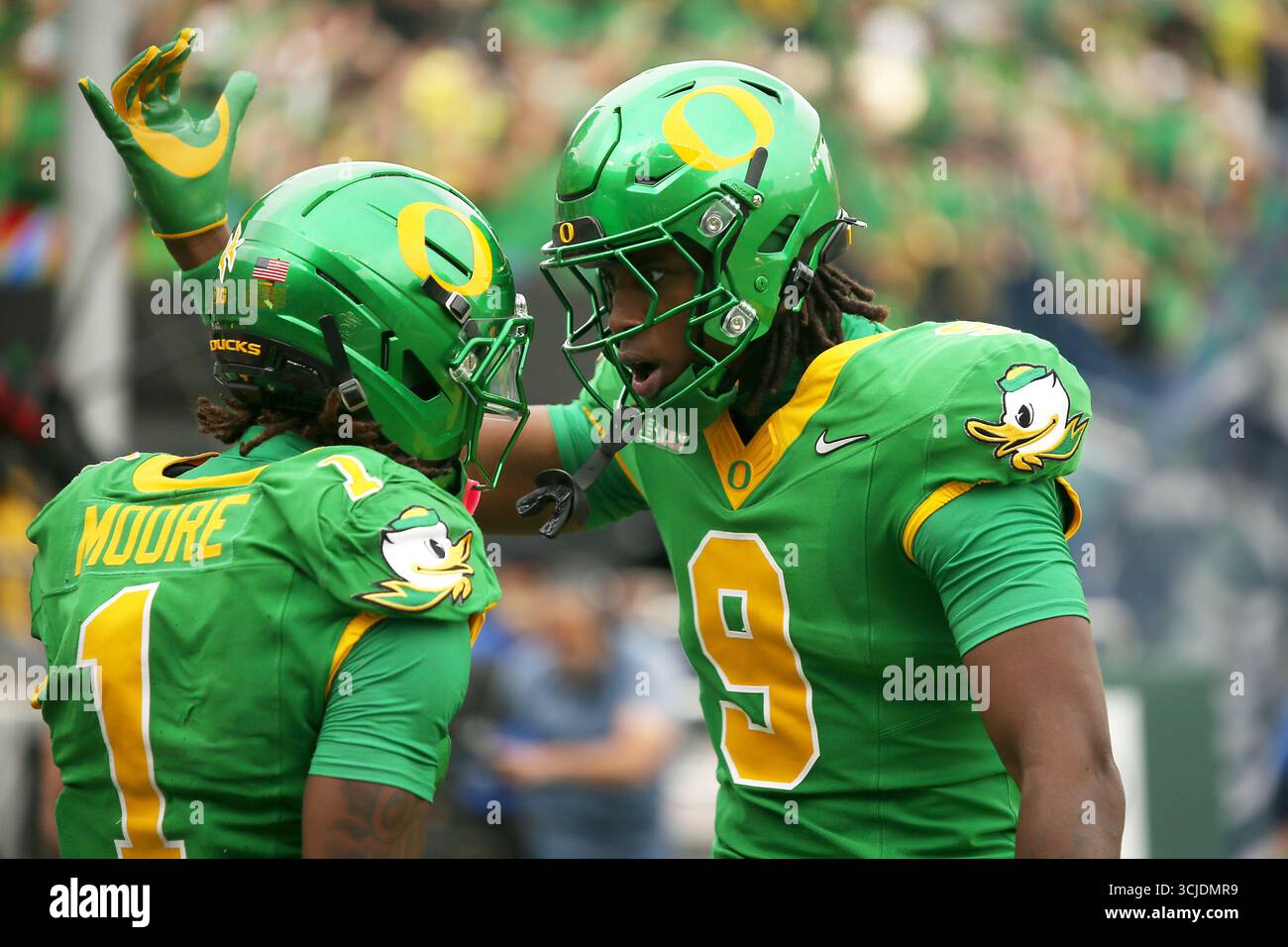 Oregon wide receiver Dakorien Moore (1) is congratulated after his ...