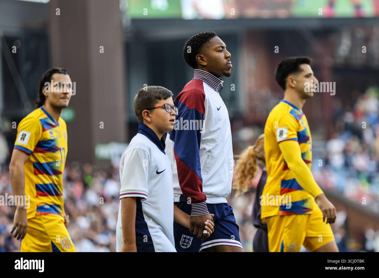 Myles Lewis-Skelly (3 England) walks out with mascot during the 2026 ...