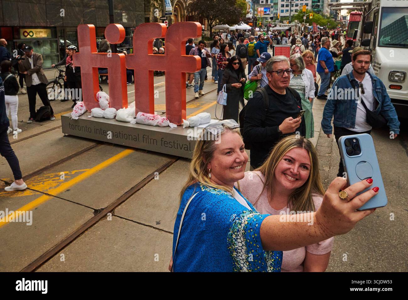People take photos by a Toronto International Film Festival sign with ...