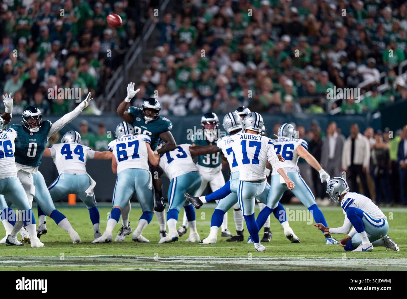 Dallas Cowboys kicker Brandon Aubrey, center right, kicks the field ...