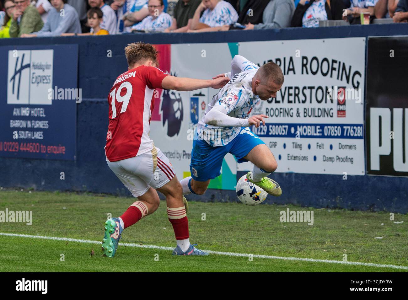 Barrow's Elliot Newby battles with Swindon Town's Joe Snowdon during ...