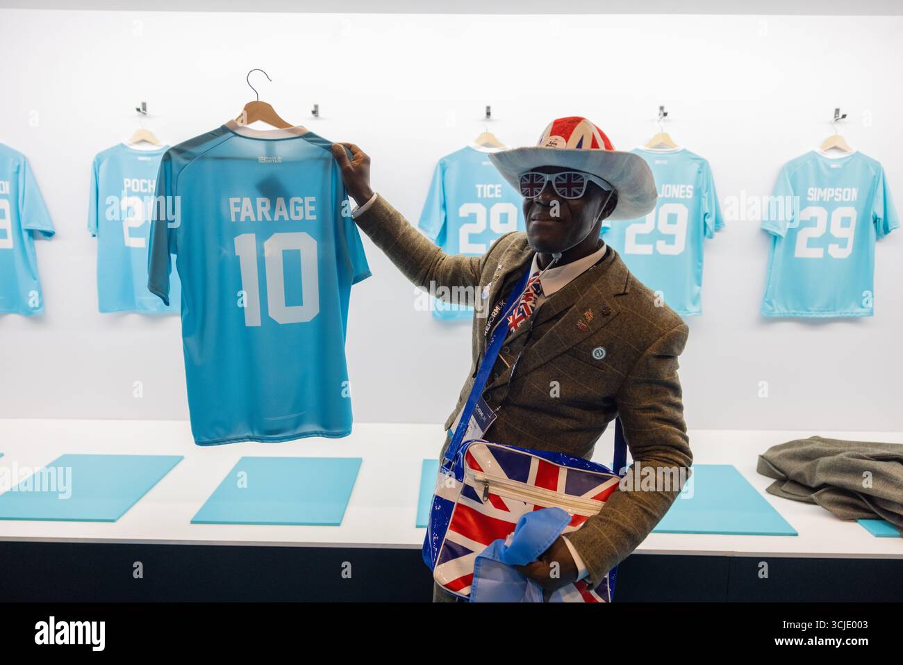 Birmingham, UK. 05 SEP, 2025. Man holds "Farage 10" football shirt on ...