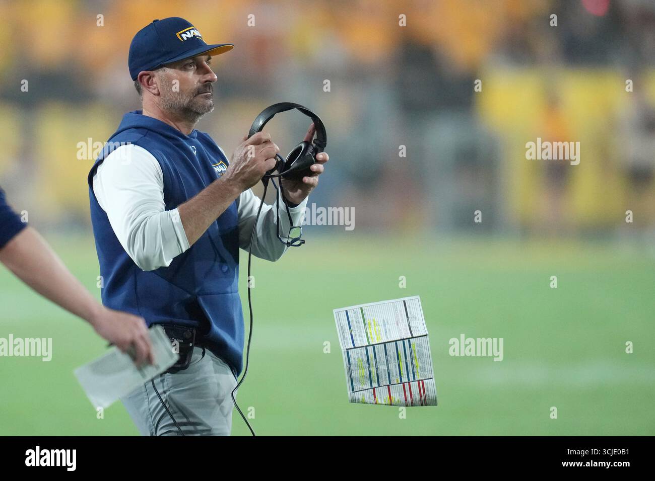 Northern Arizona head coach Brian Wright puts his headset back on ...