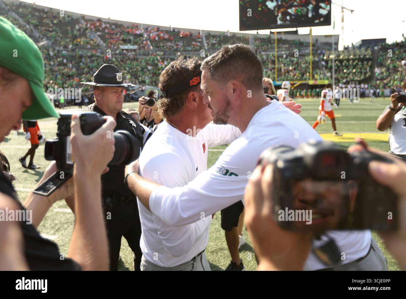 Oregon head coach Dan Lanning, right, greets Oklahoma State head coach ...