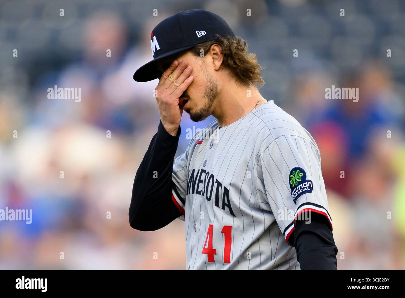 Minnesota Twins starting pitcher Joe Ryan wipes his face after issuing a second walk during the ...