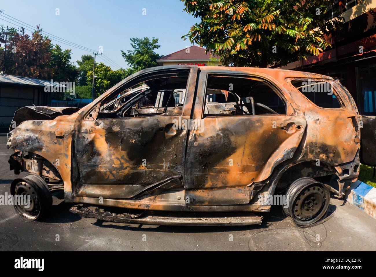The car after it caught fire. Some parts of the car appear charred ...