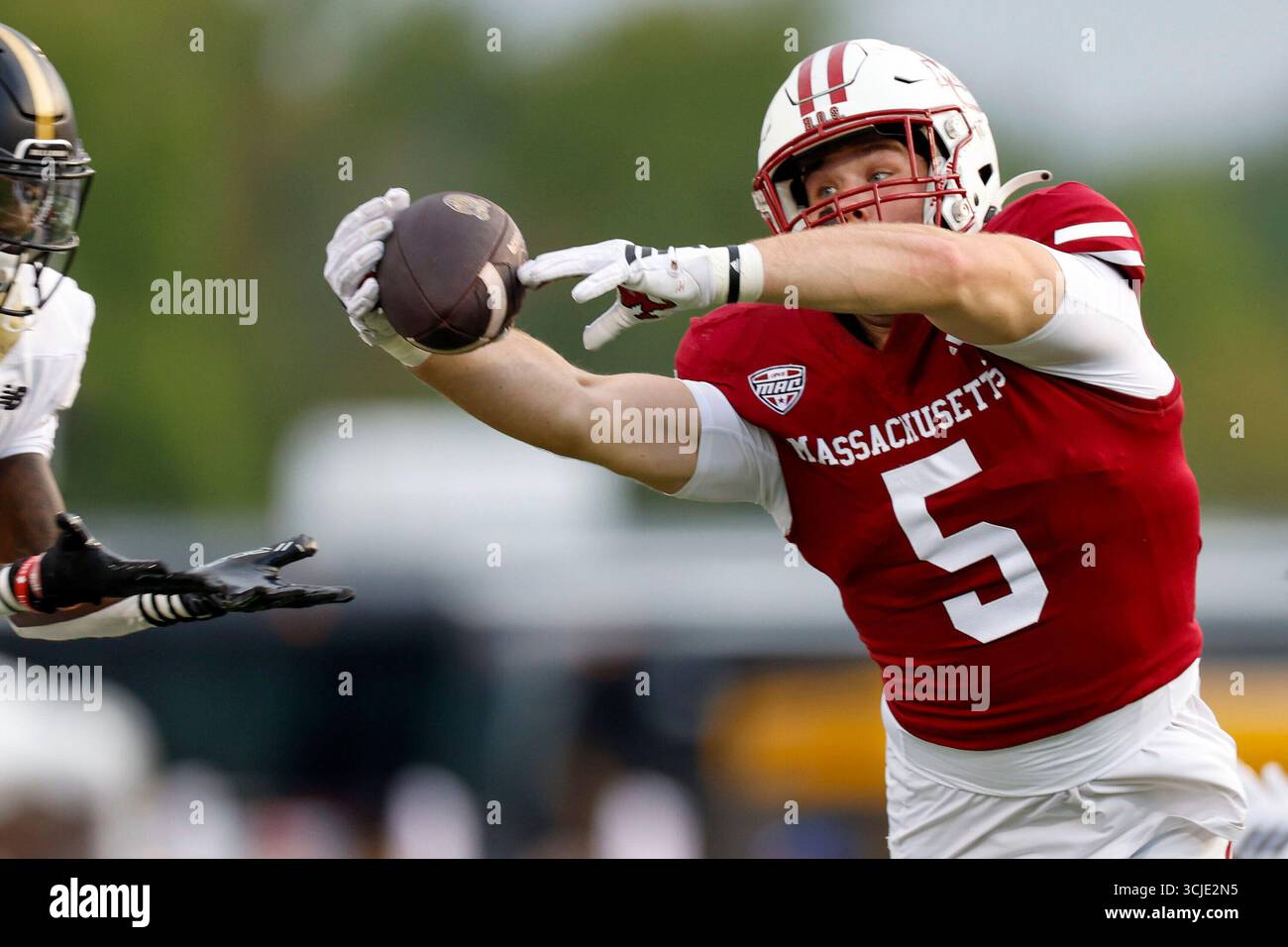 Massachusetts linebacker Tyler Martin (5) intercepts a pass intended ...
