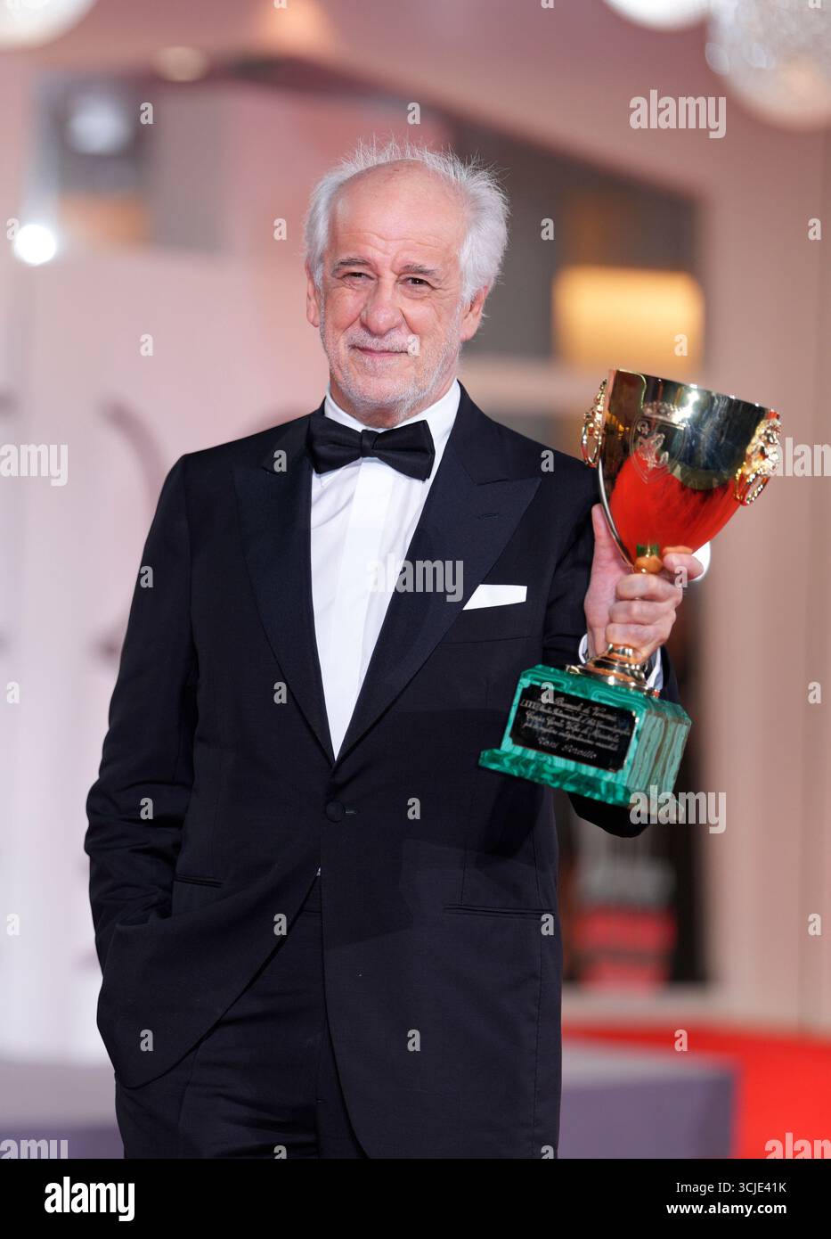 VENICE, ITALY - SEPTEMBER 06: Toni Servillo poses with the Coppa Volpi ...