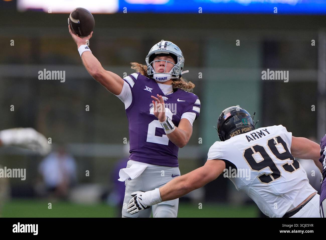 Kansas State quarterback Avery Johnson (2) passes over Army defensive ...