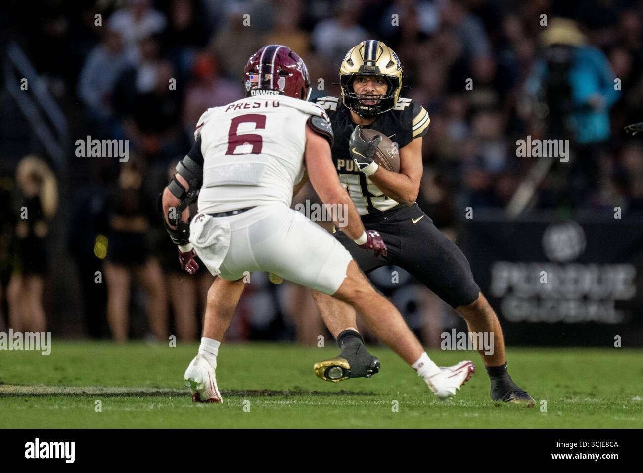 Purdue running back Devin Mockobee (45) runs the ball while being ...
