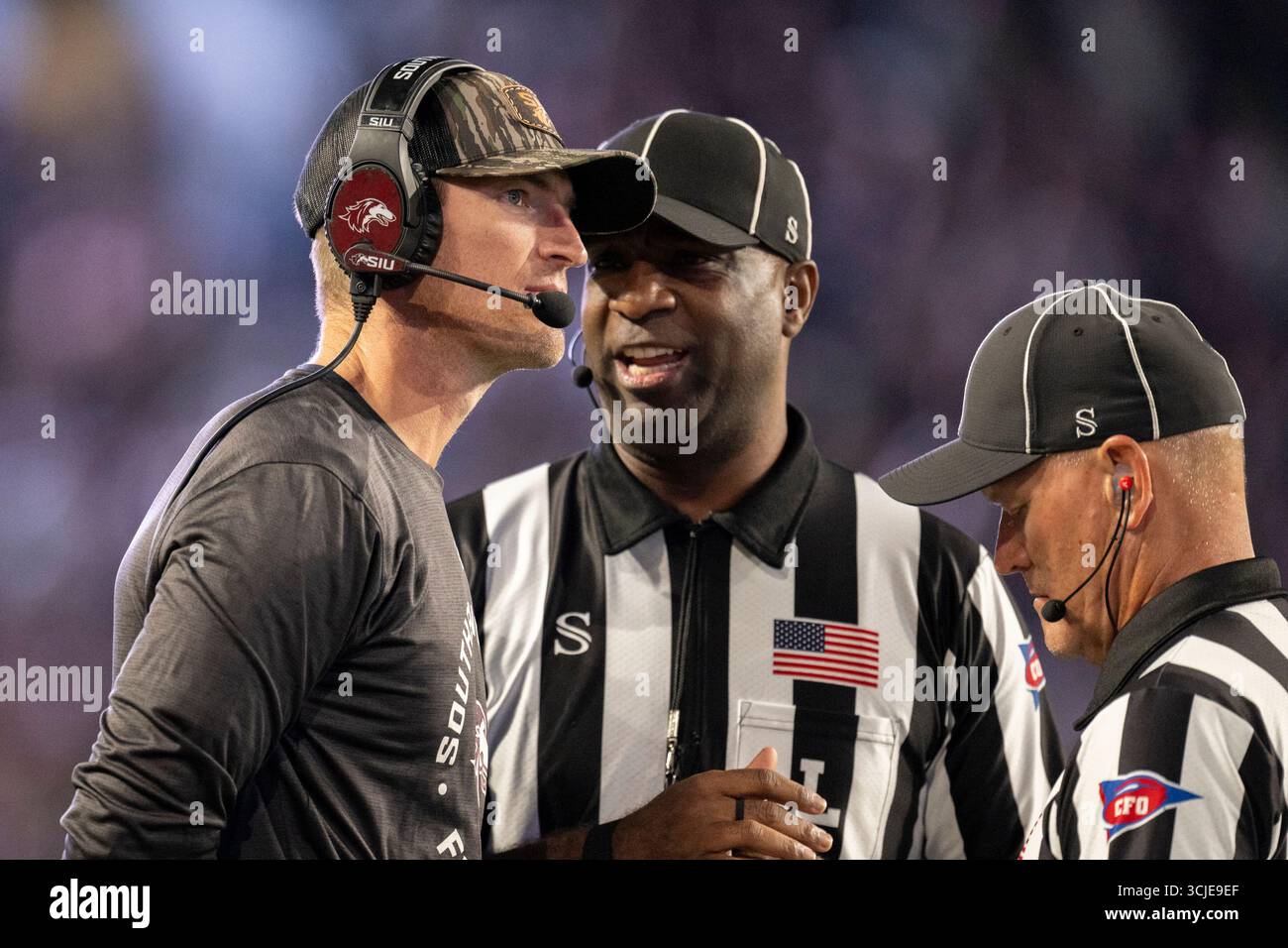 Southern Illinois head coach Nick Hill, left, talks with game officials ...