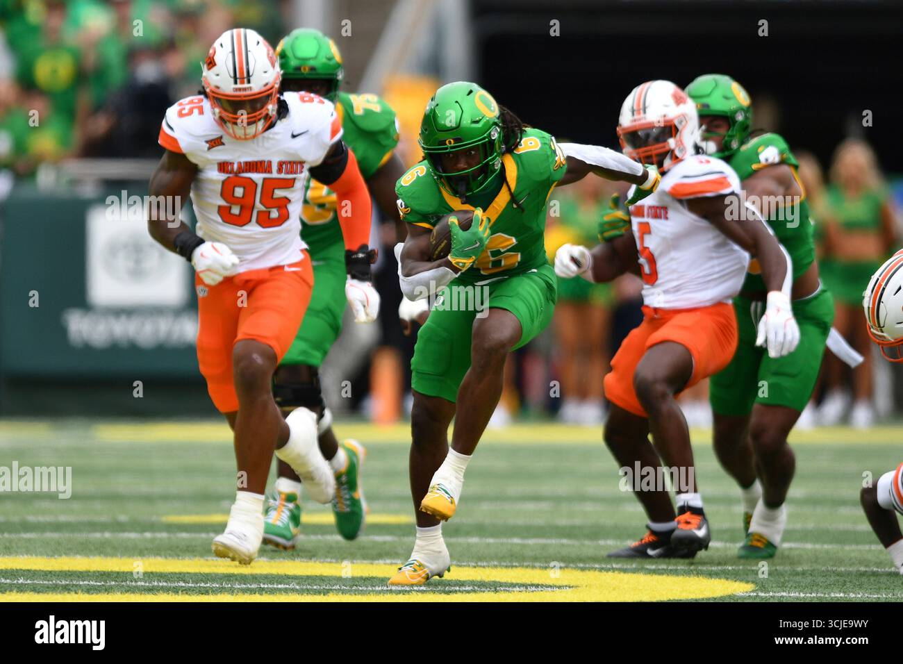 Oregon running back Noah Whittington (6) runs away from Oklahoma State ...