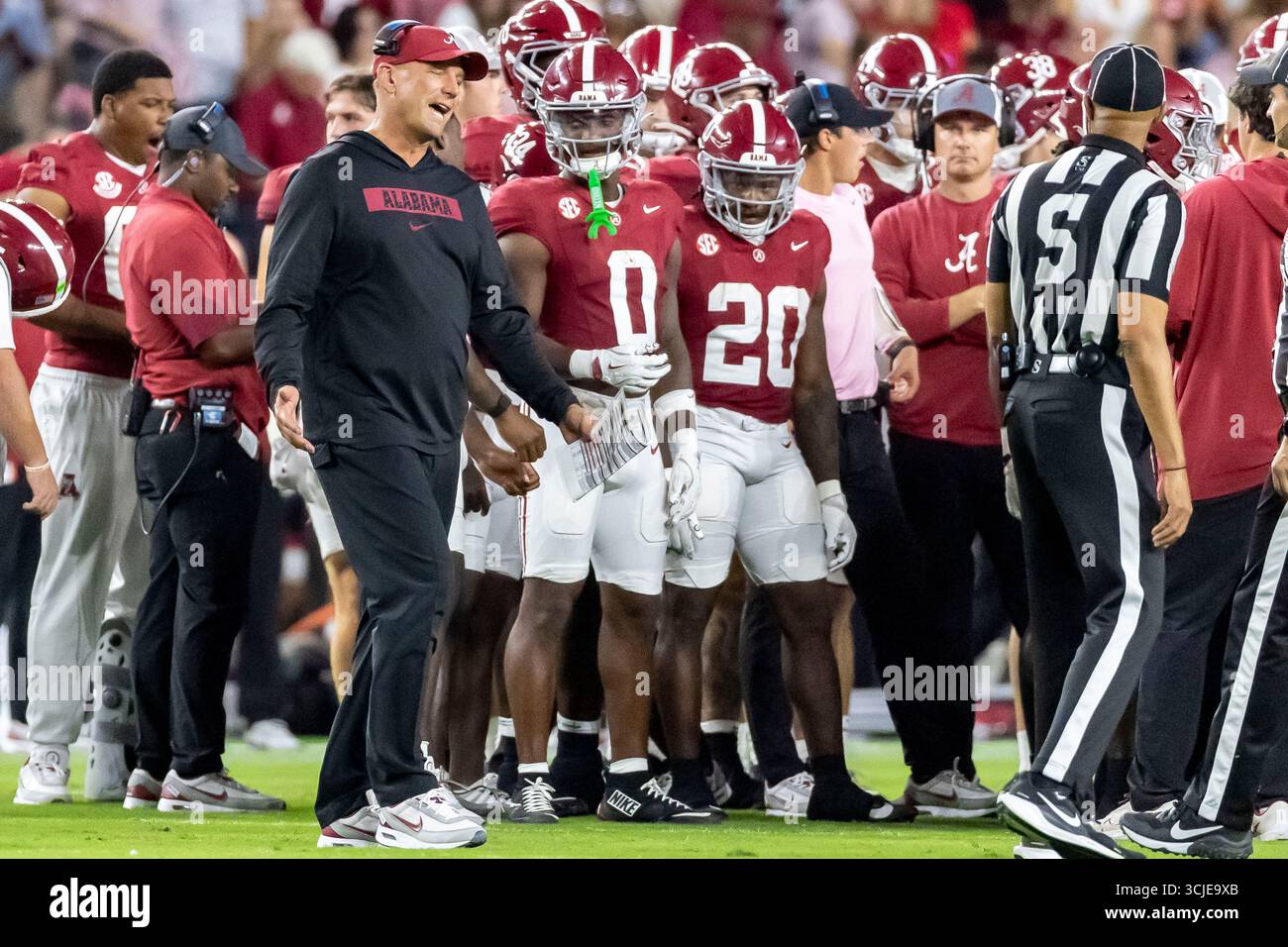 Alabama head coach Kalen DeBoer, front left, talks with a referee ...