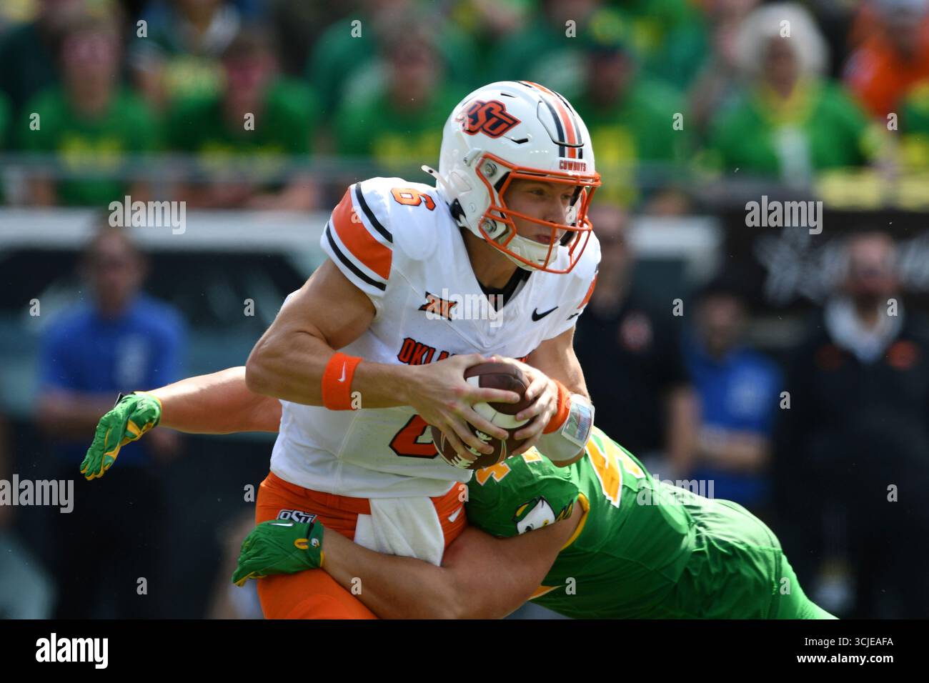 Oregon linebacker Teitum Tuioti (44) sacks Oklahoma State quarterback ...