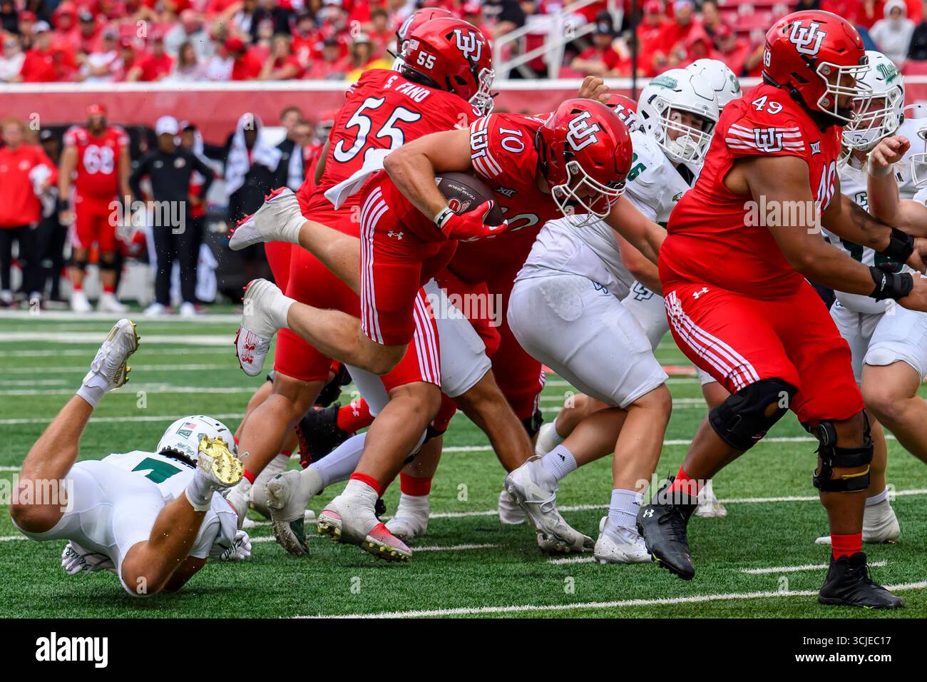 Utah tight end Hunter Andrews (10) goes airborne to gain extra yards ...