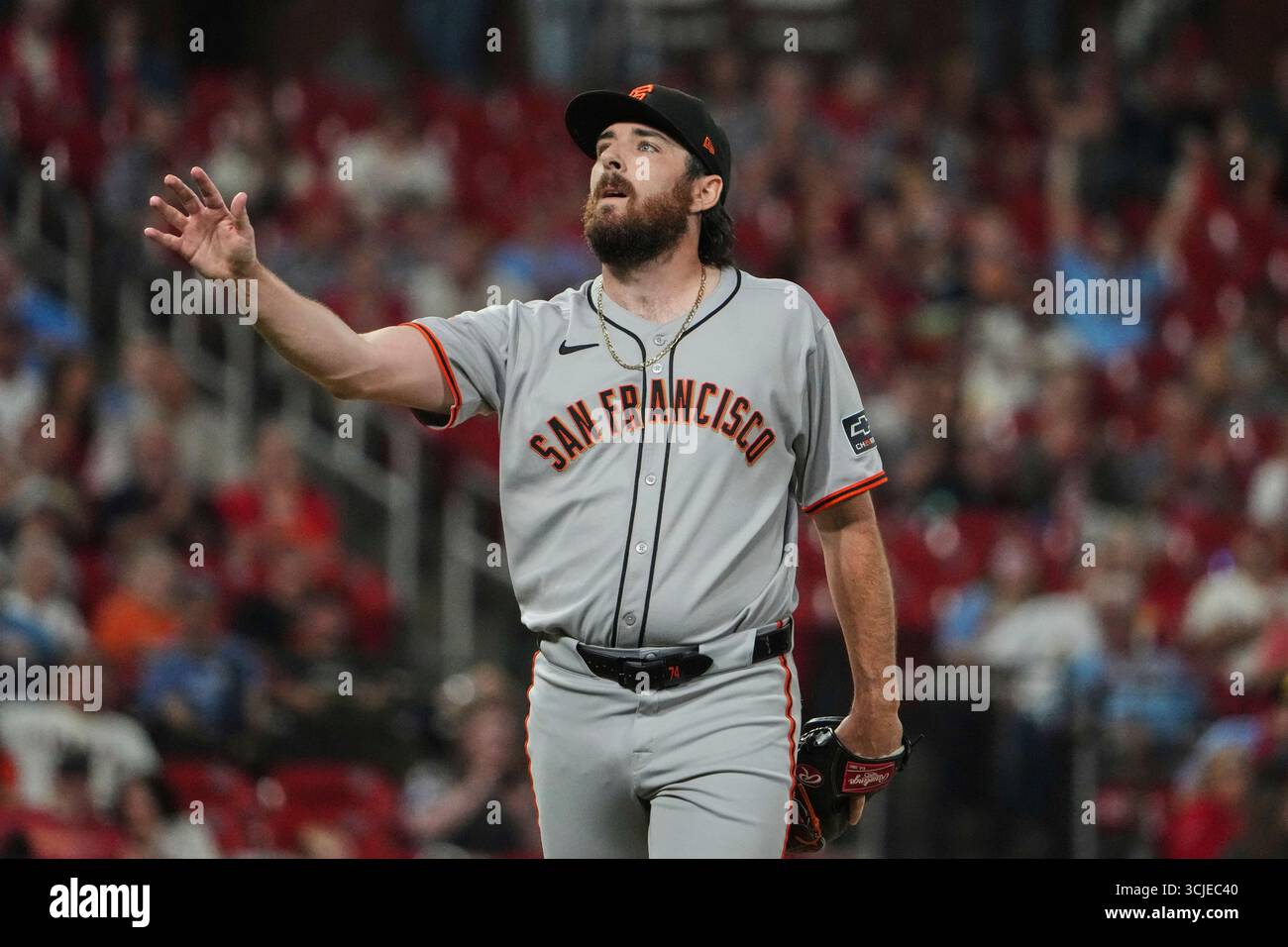 San Francisco Giants pitcher Ryan Walker reacts after hitting St. Louis ...