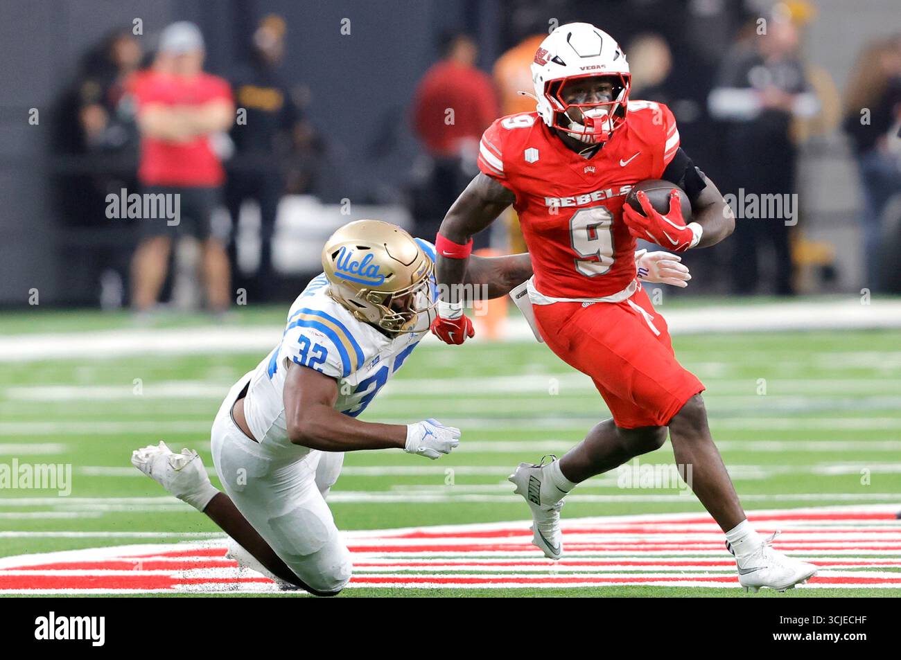UNLV Rebels running back Jai'Den Thomas (9) avoids a tackle by UCLA ...