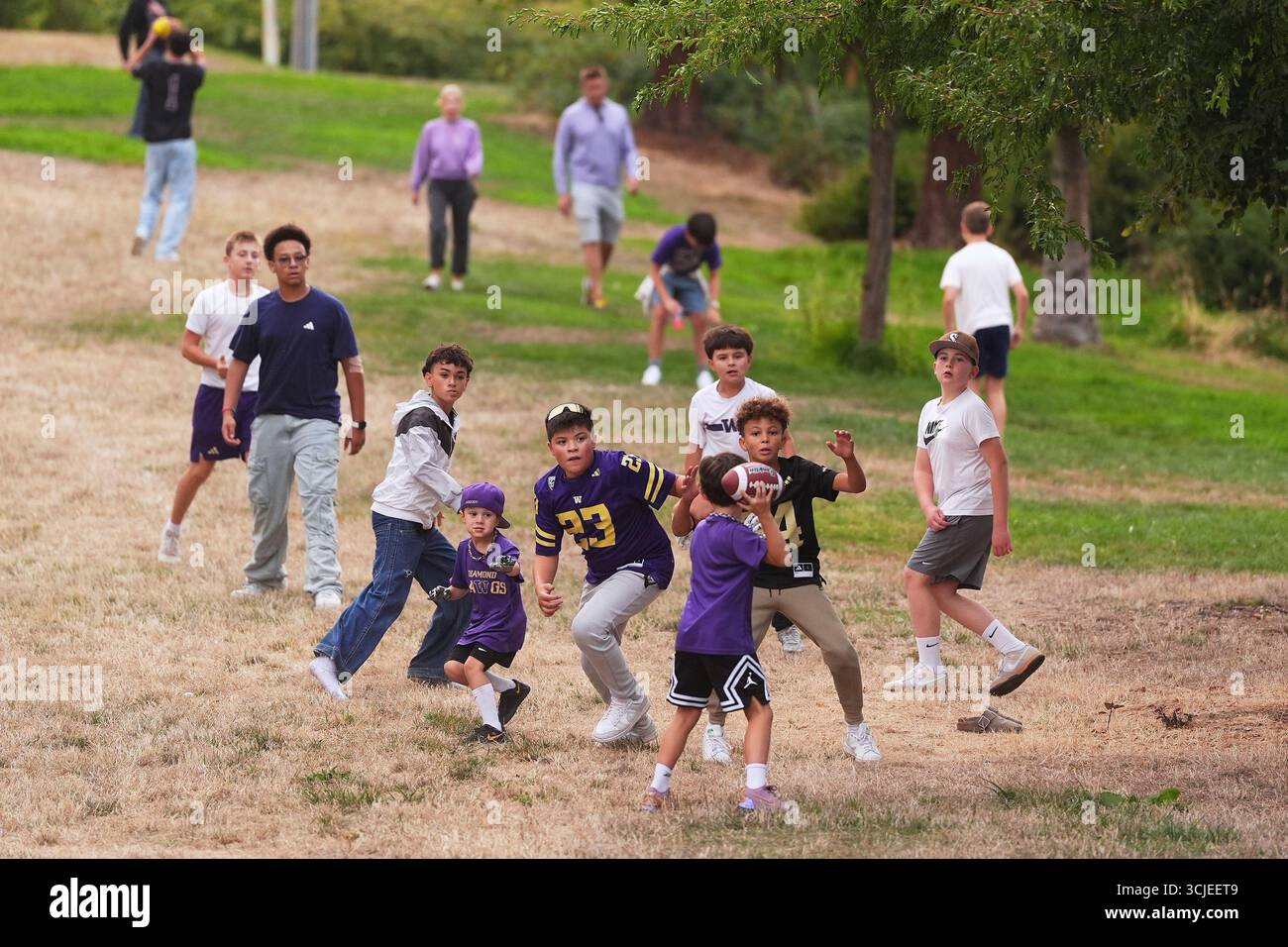 Young Washington fans play while tailgating before an NCAA college ...