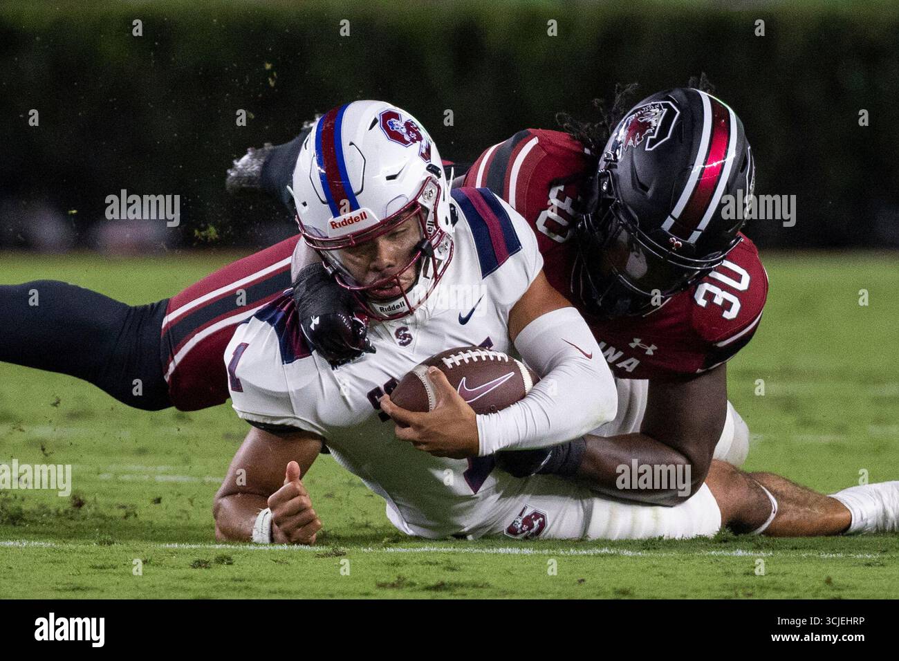 South Carolina State quarterback William Atkins IV (1) gets sacked by ...