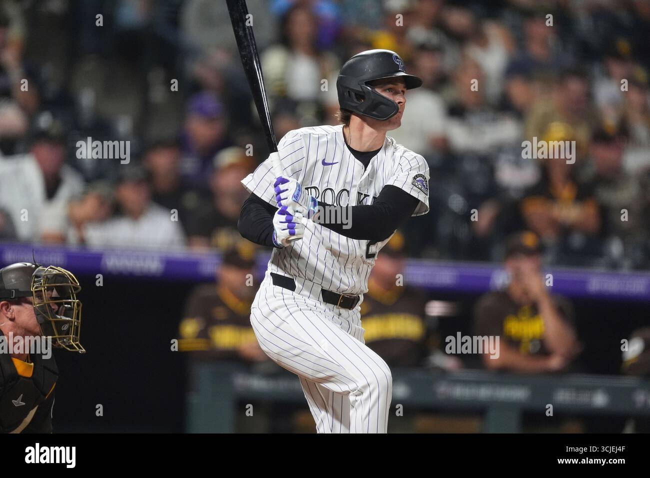 Colorado Rockies' Mickey Moniak follows the flight of his solo home run ...