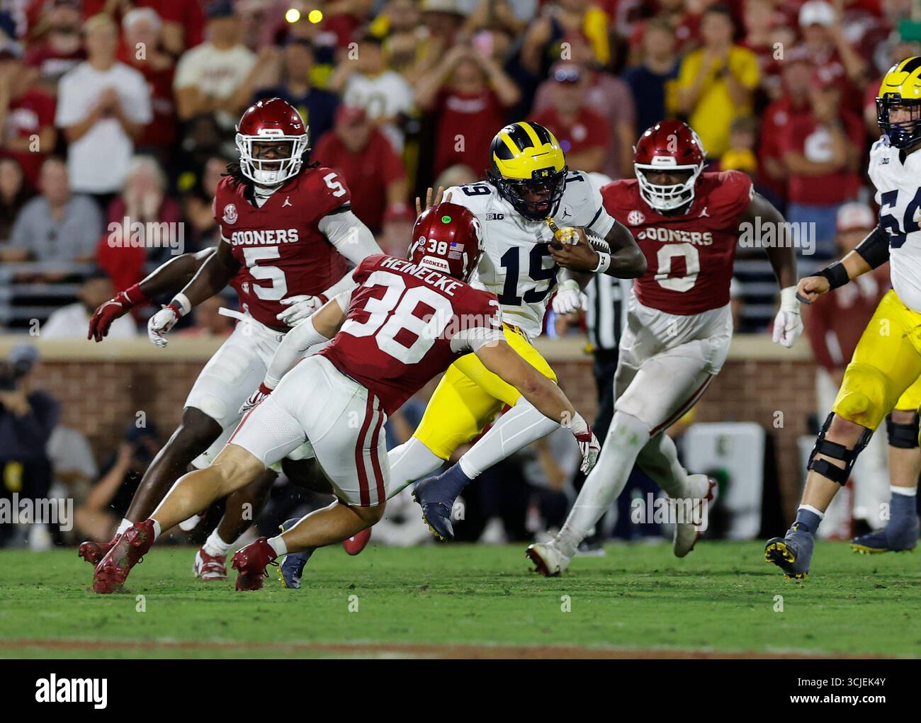 Michigan quarterback Bryce Underwood (19) stiff-arms Oklahoma ...