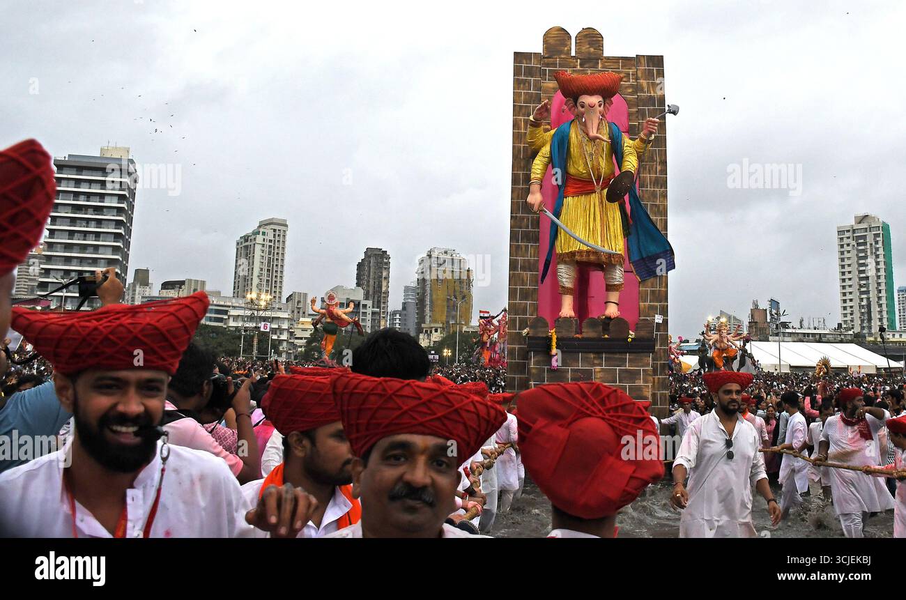 Devotees seen wearing red coloured turban carry an idol of elephant ...