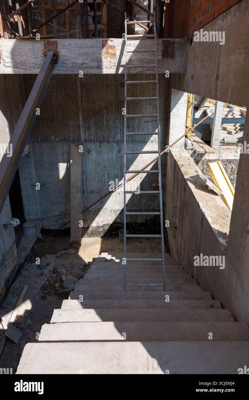 Scaffolding at a construction site. Stairs architecture unfinished at ...