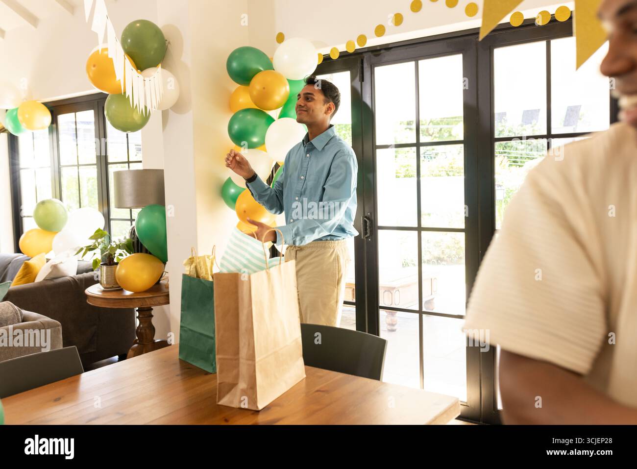 Man decorating living room balloons hi-res stock photography and images ...