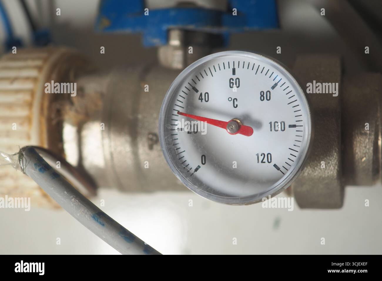 Temperature gauge on a valve in a plumbing system Stock Photo - Alamy