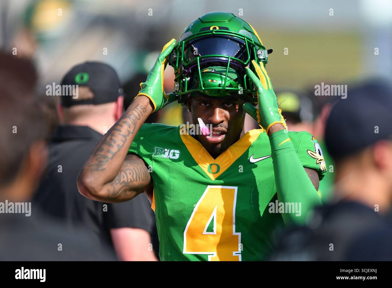 Oregon wide receiver Malik Benson (4) puts his helmet back on while ...