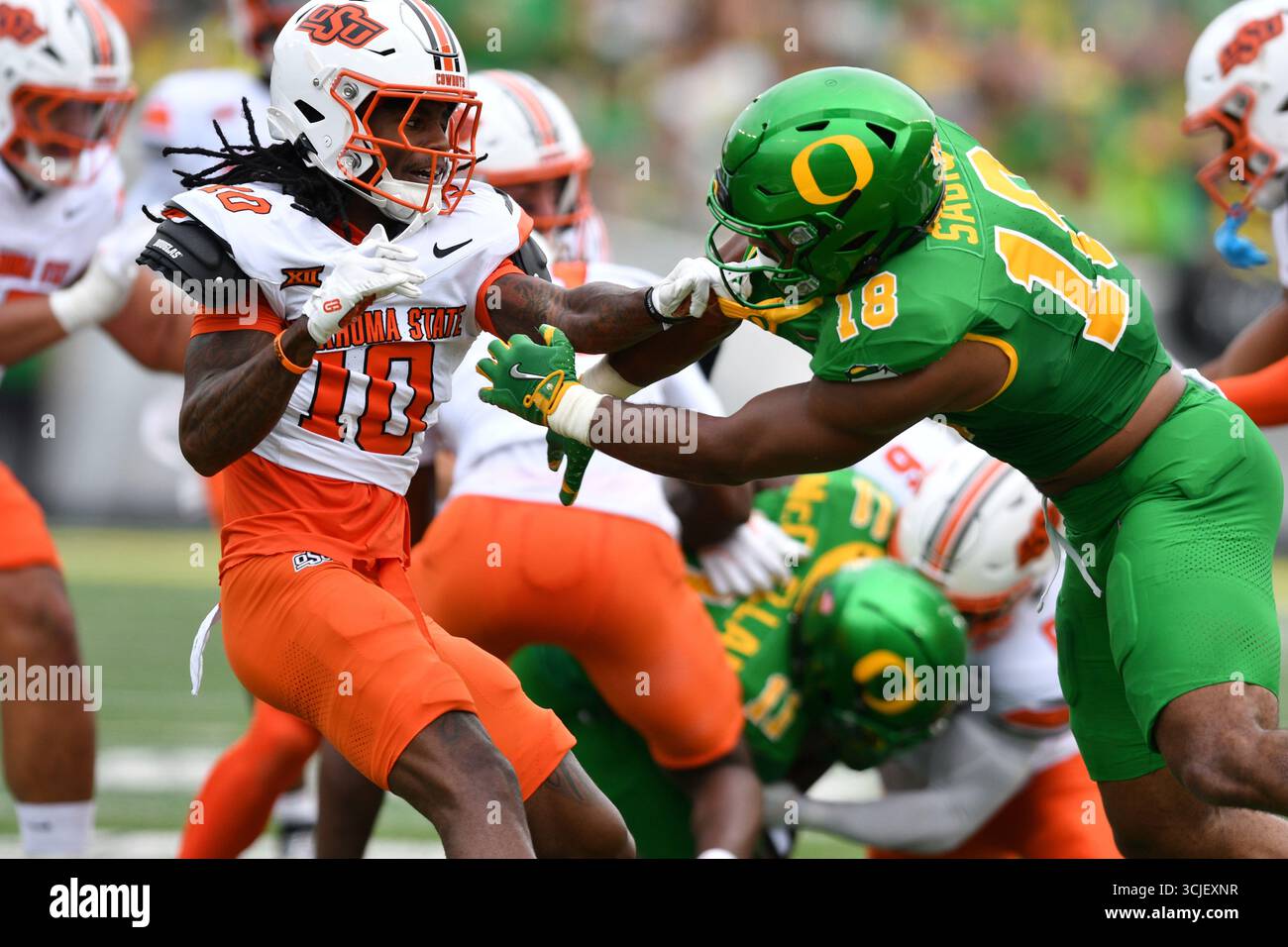 Oklahoma State cornerback Kale Smith (10) fights off the block of ...