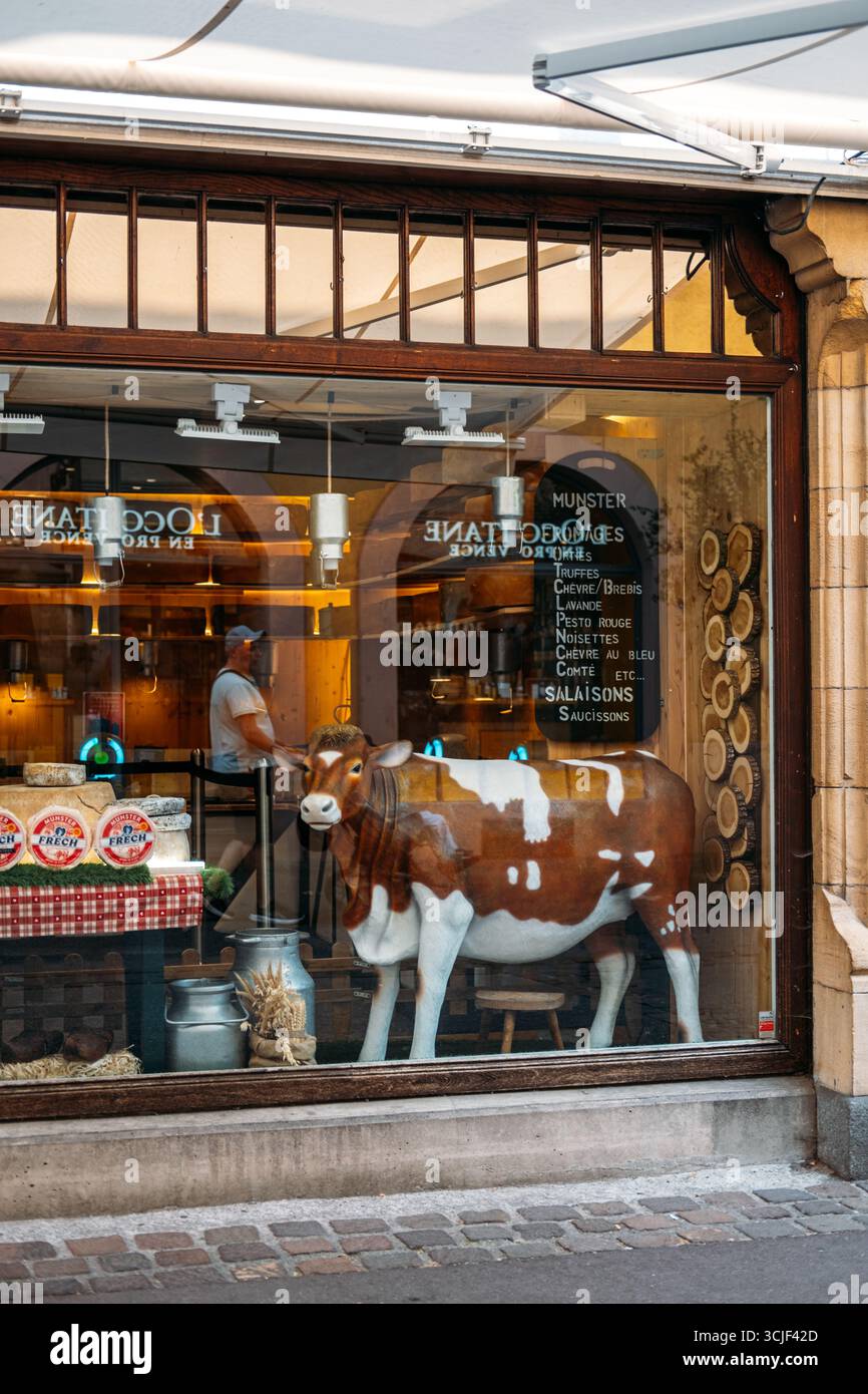 Cheese shop window display in Colmar old town featuring a cow statue ...