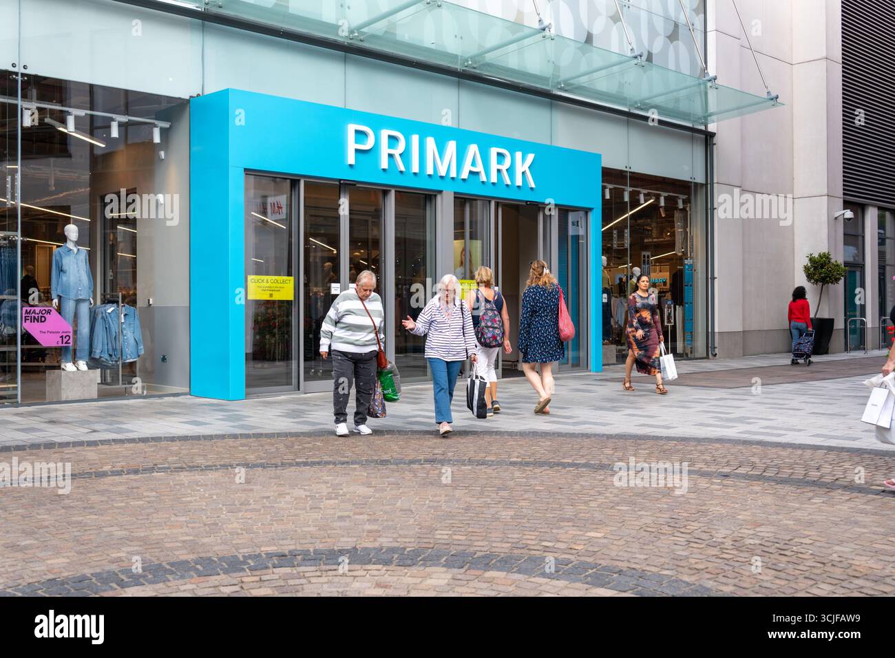 Sept 2025 Clothes shoppers with bags going into and out of a Primark ...