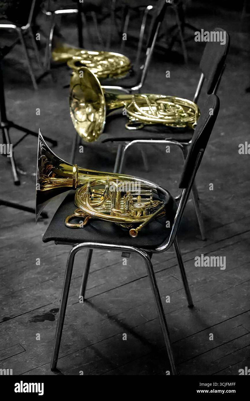 Image of a brass musical instrument horn lying on a chair Stock Photo ...