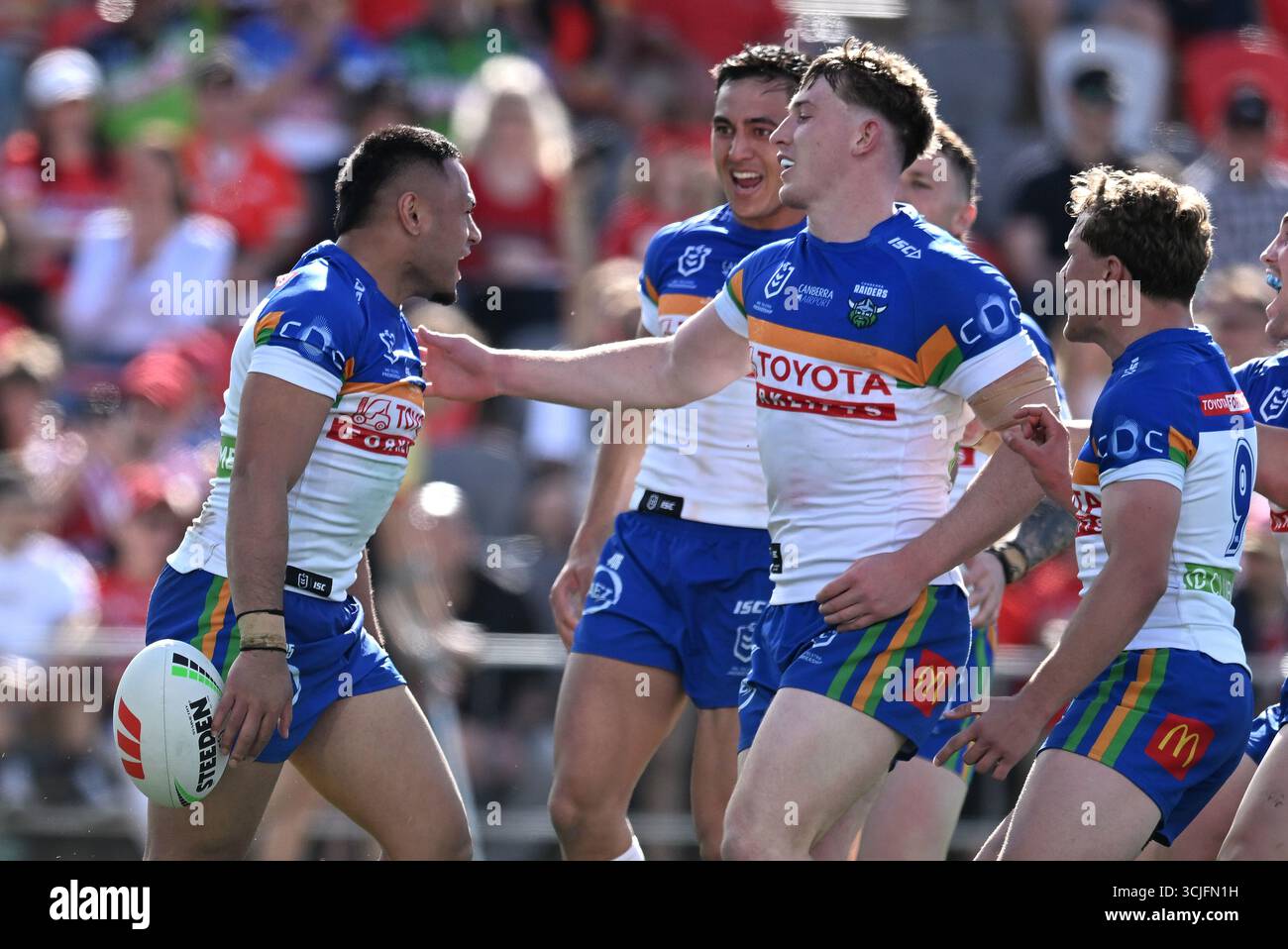 Michael Asomua (left) of the Raiders celebrates scoring a try with team ...