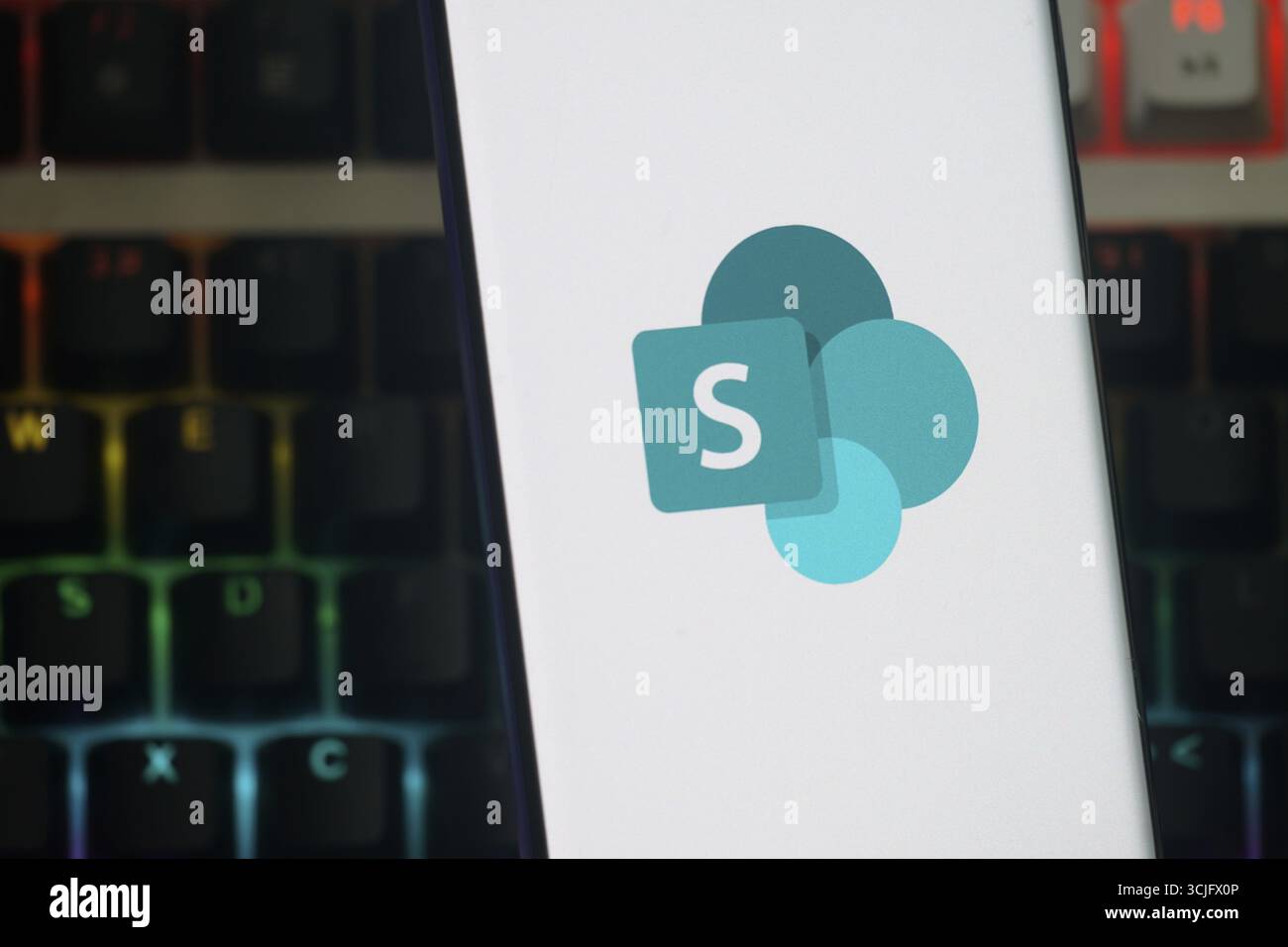 SharePoint app logo with blue and green circles on a smartphone screen ...